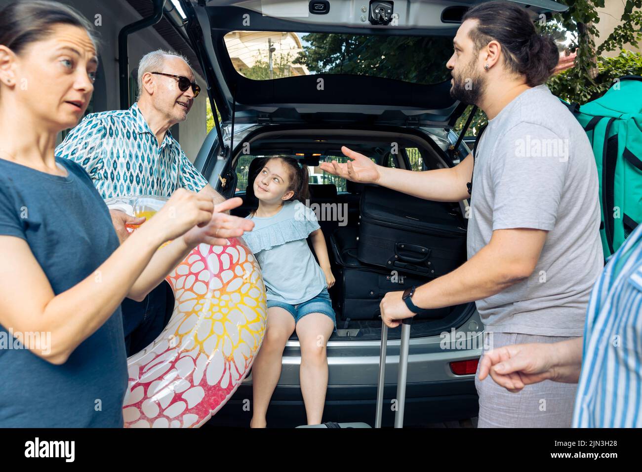 European family travelling on vacation trip, loading baggage and ...