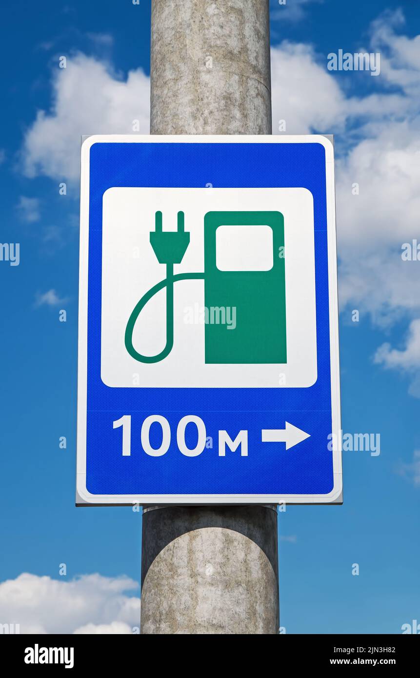 Road sign - electric charging station hanging on large reinforced ...