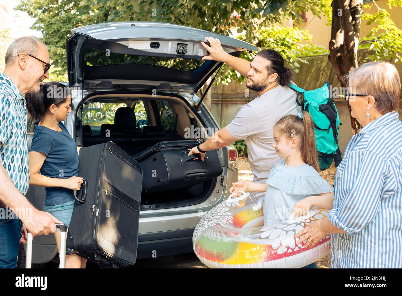 Big european family going on holiday vacation and loading baggage in ...