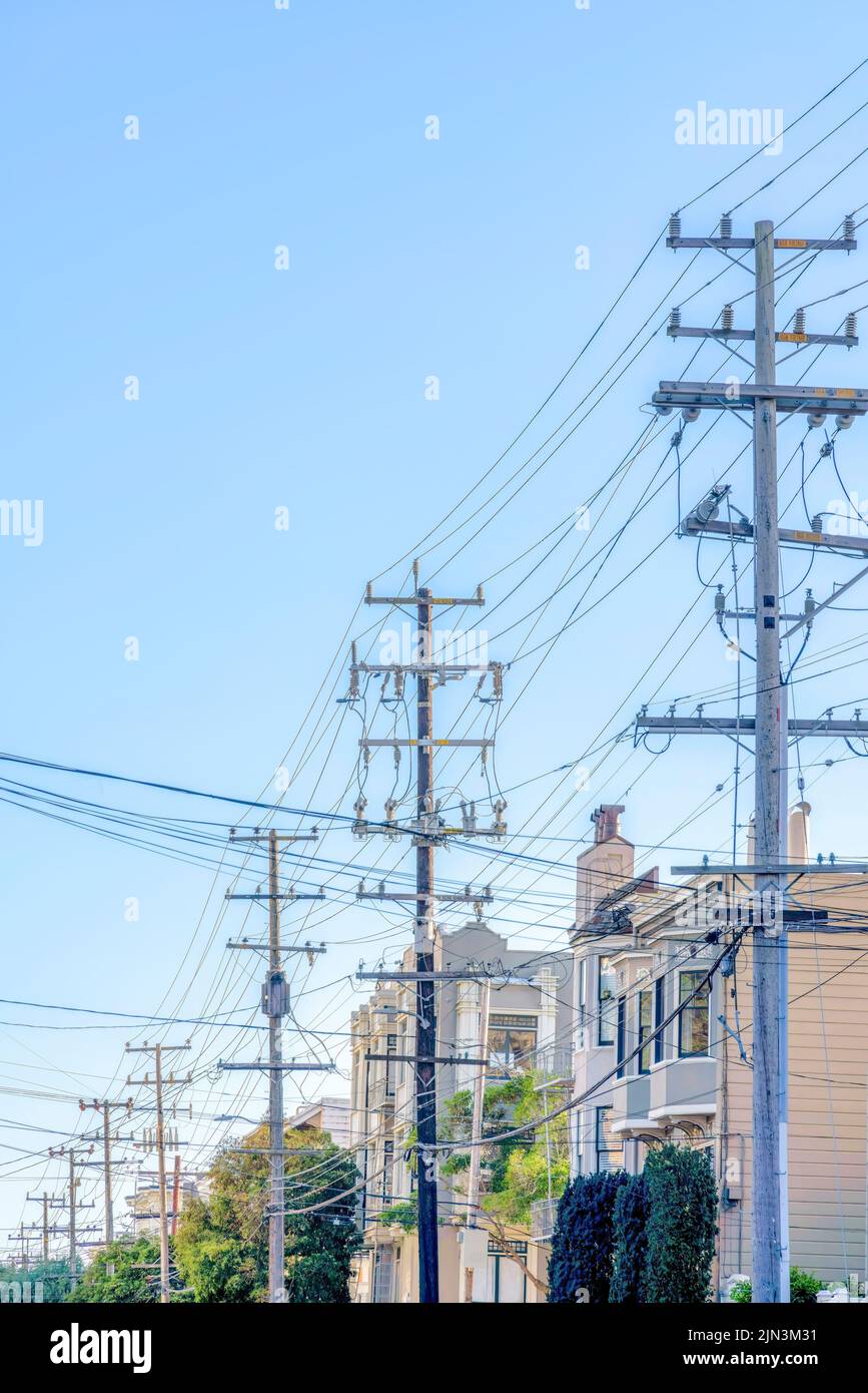 Row of electrical posts with tangled wires in the urban area of San ...