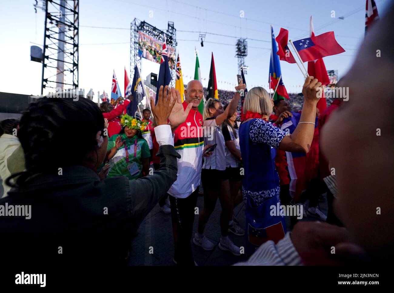 Athletes high five fans as they enter the stadium during the Closing ...