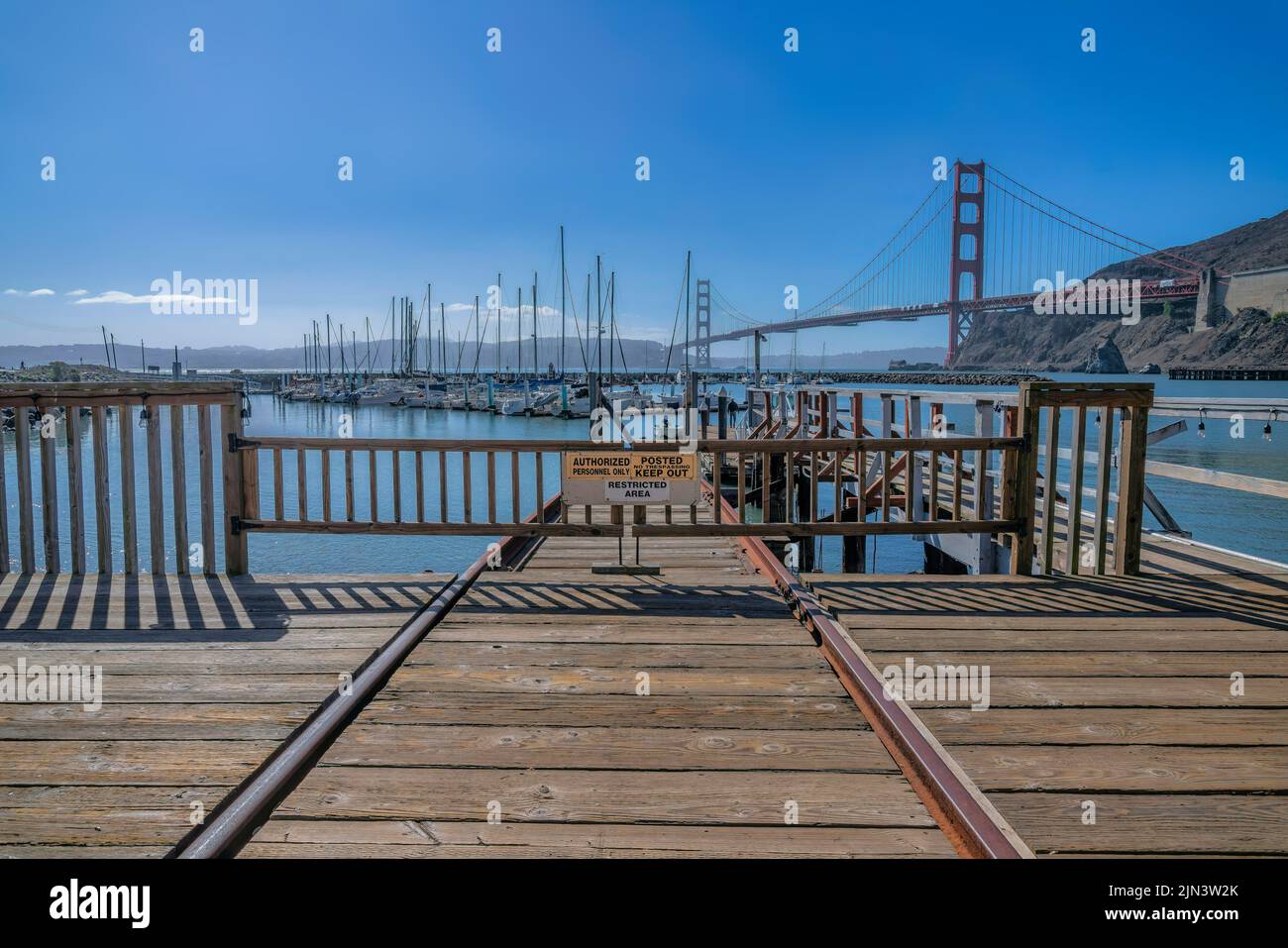 Closed dock with signages at the harbor against the Golden Gate Bridge ...