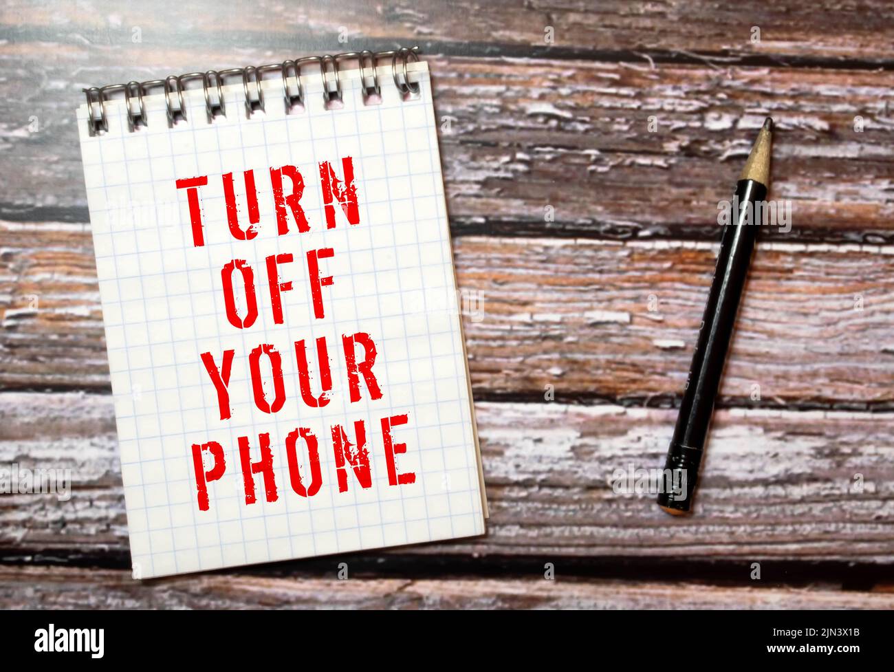 Business man pointing the text Turn Off Your Phone Stock Photo - Alamy