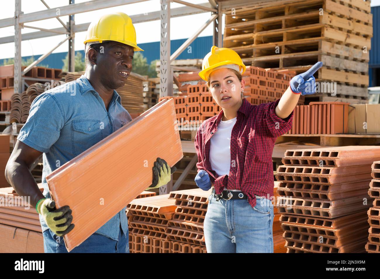 Warehouse workers in outdoor construction material storage Stock Photo ...