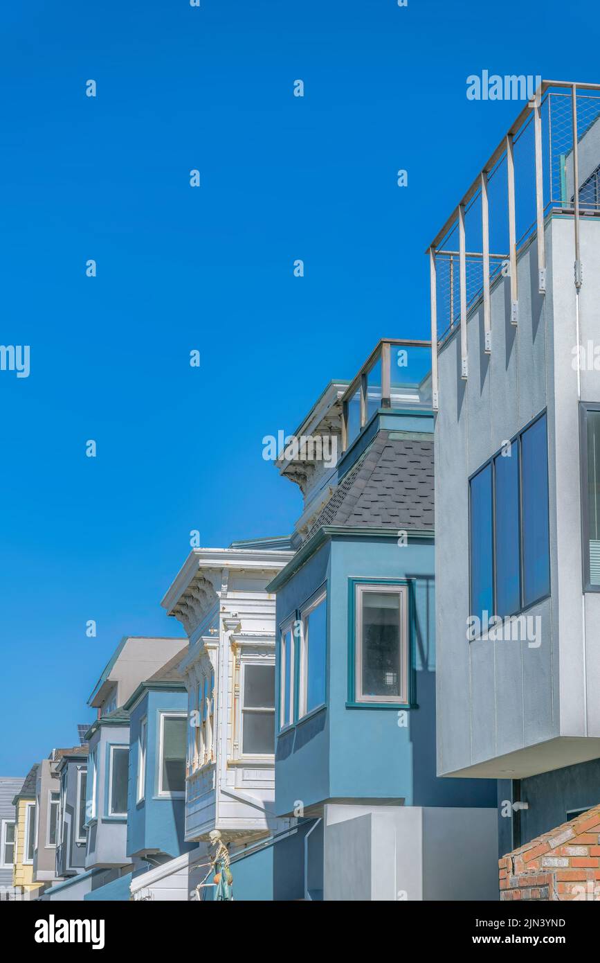 Side view of row of houses with protruding windows against the sky in ...