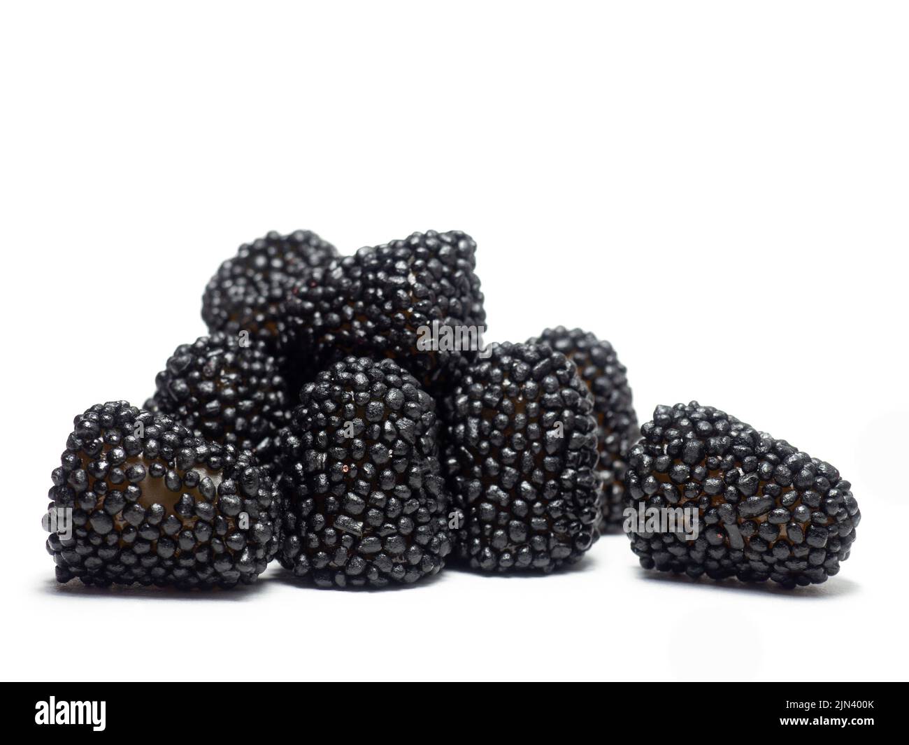 black chewy candies in the form of berries. Sweets in the form of ...