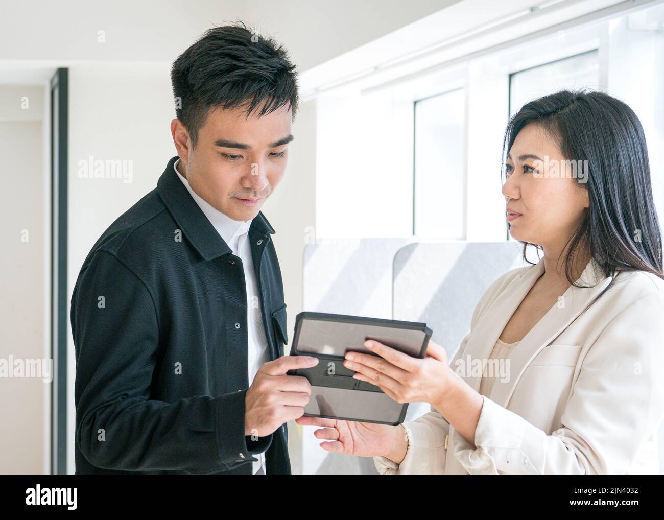 Business colleagues having a discussion while looking at digital tablet ...