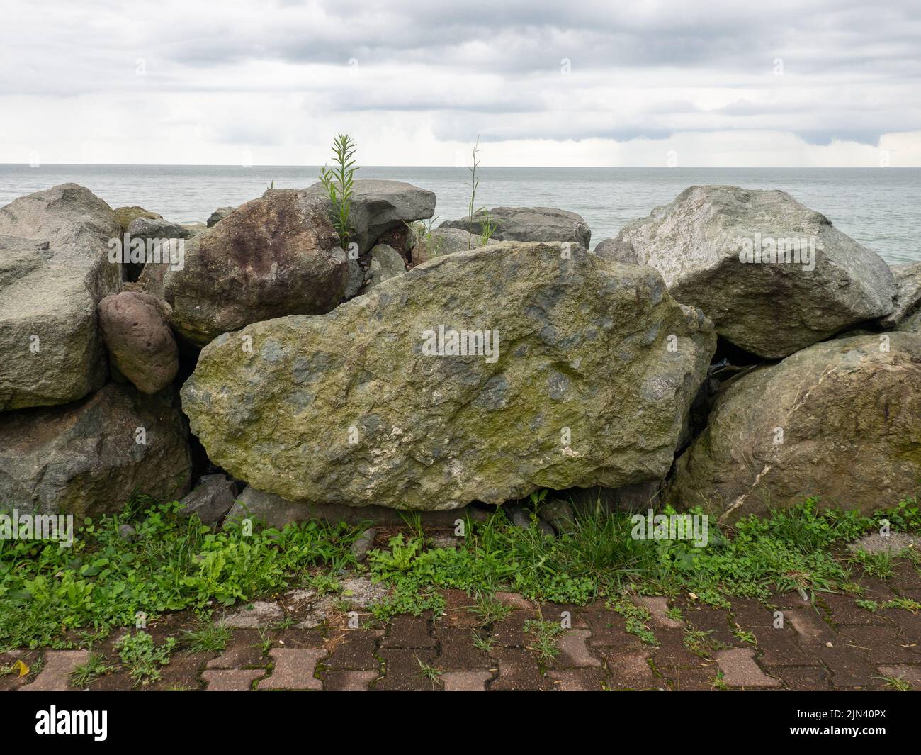 Barrier of large stones on the seashore. Wave protection. Irregular ...