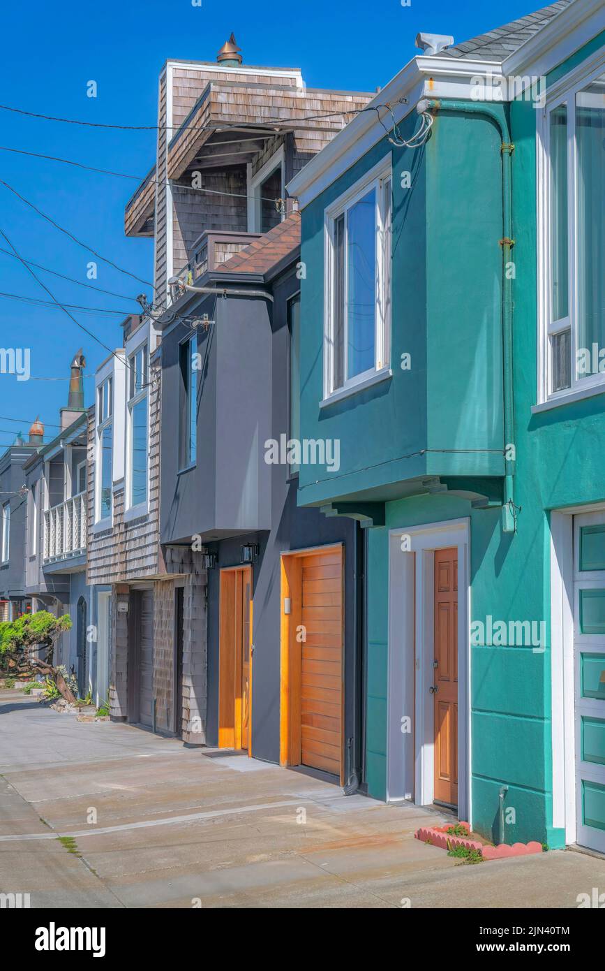 Small suburban houses with attached garages and view of electrical ...