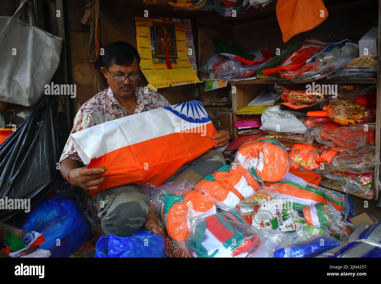 Kolkata, India. 08th Aug, 2022. A shopkeeper sells Indian national ...