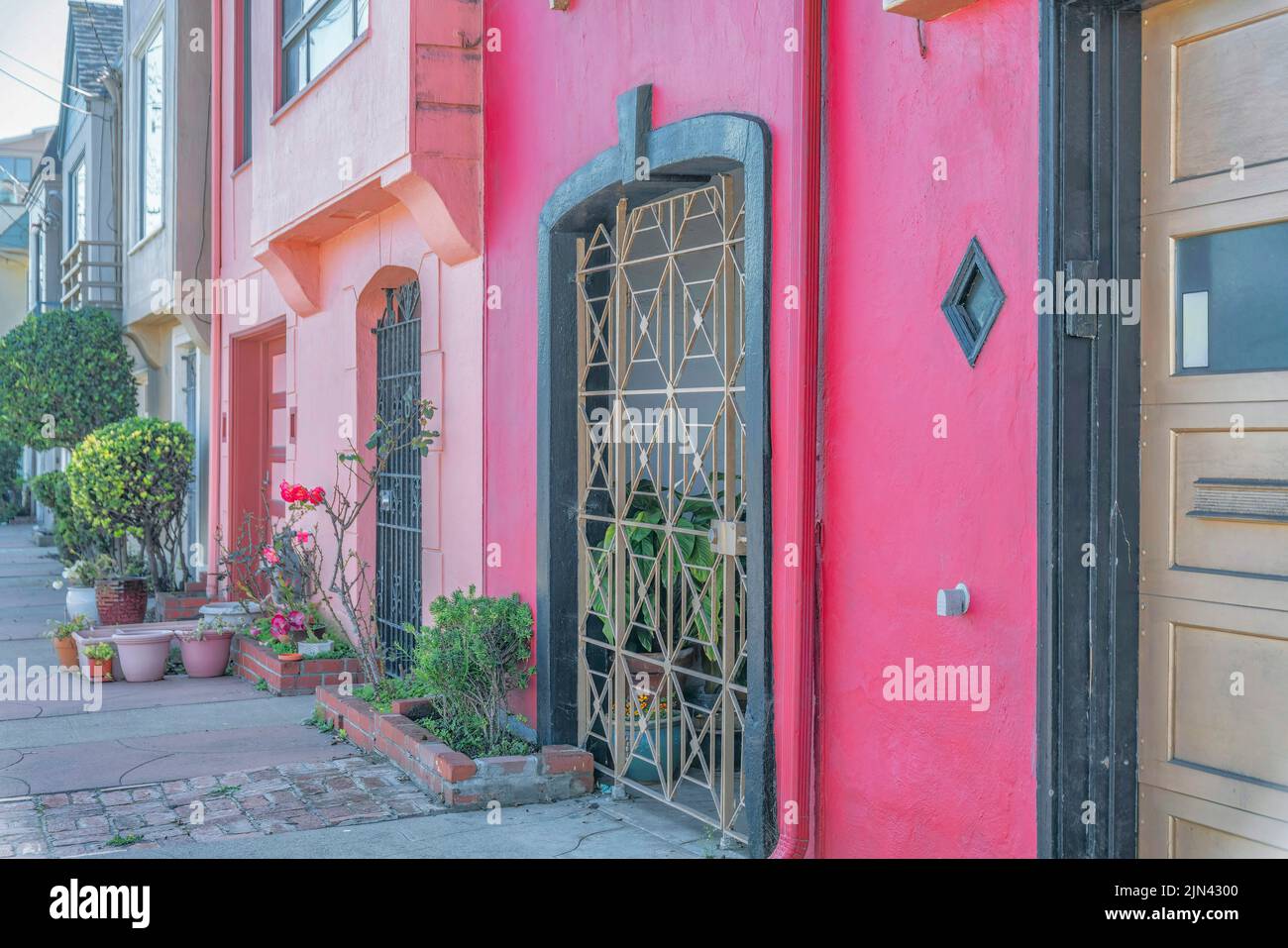 Entrances of an adjacent houses with attached garage and iron single ...