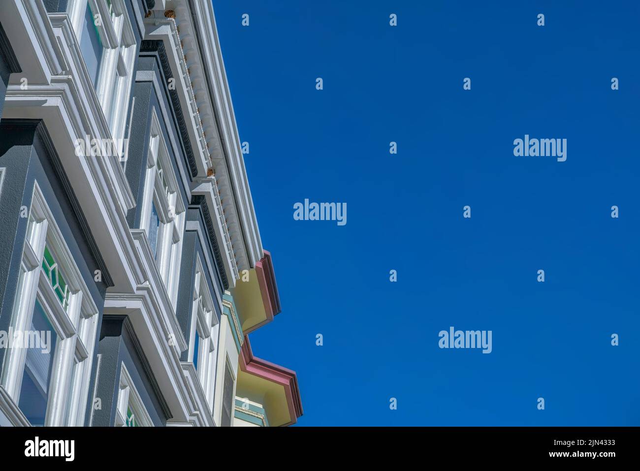 White trims of a house in a low angle view against the clear blue sky ...