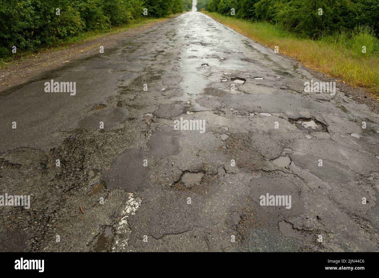 Very bad road surface. Holes on the road Stock Photo - Alamy