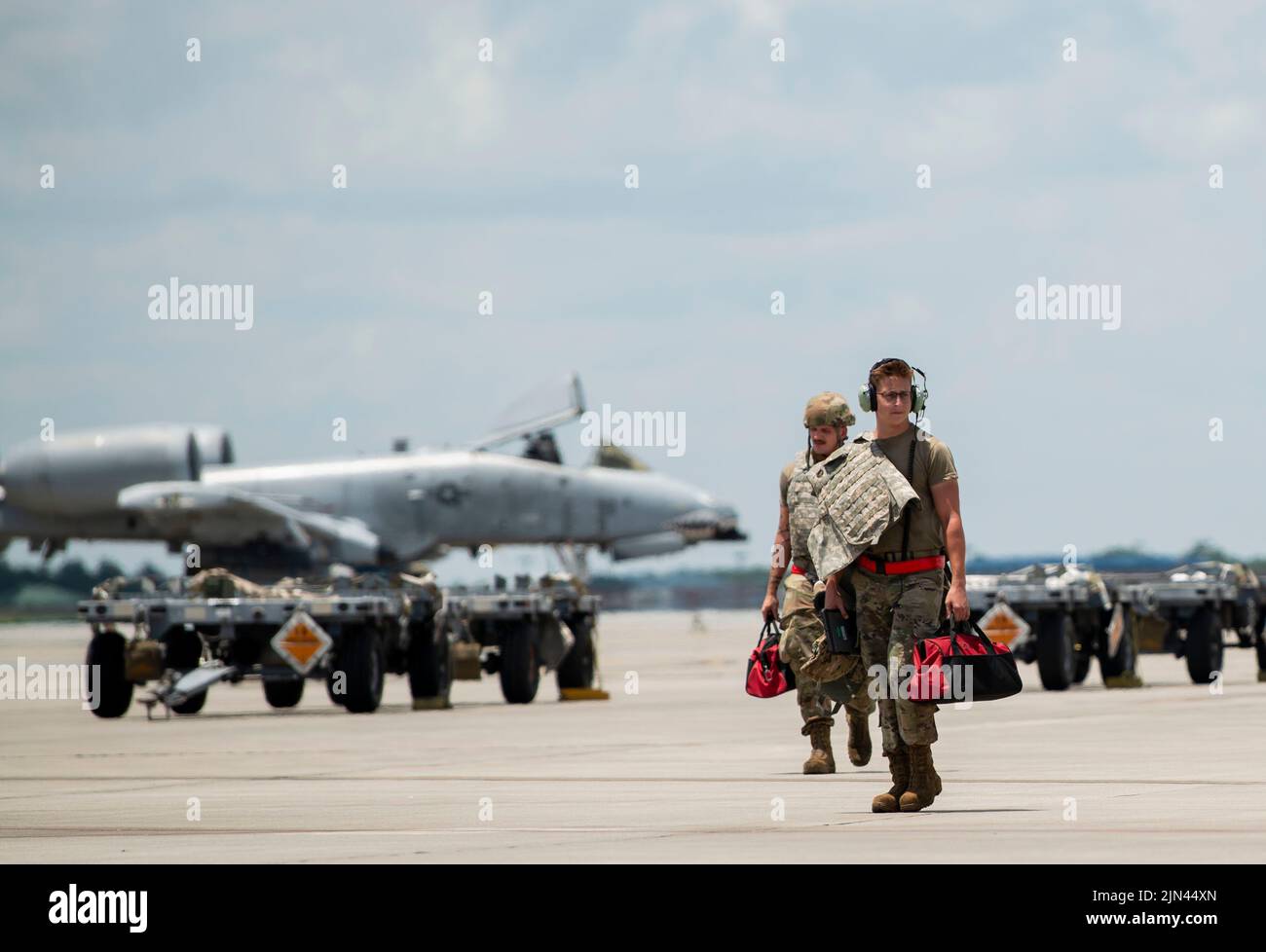 U.S. Air Force Airmen assigned to the 23rd Wing carry gear from the ...