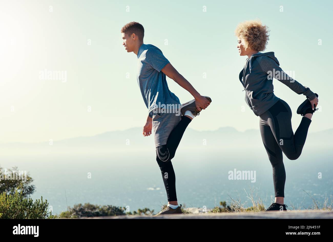 Your partner is your motivation. a young couple warming up before their ...