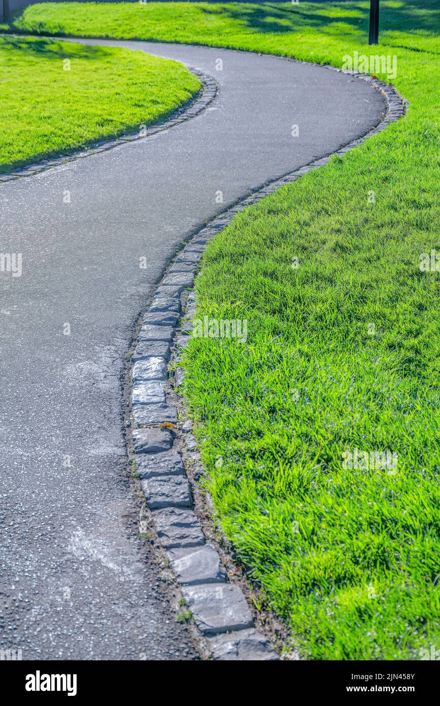 Curved asphalt trail with stone trims on the side in San Francisco ...