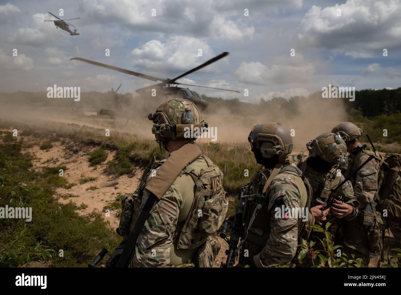 Operators from the 20th Special Forces Group move back to a UH-60 ...