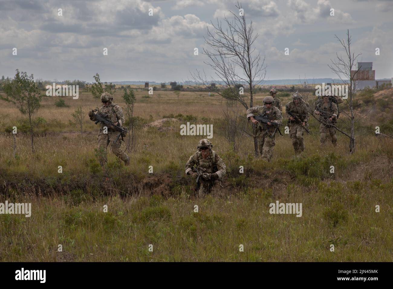 Operators from the 20th Special Forces Group run to a landing site to ...