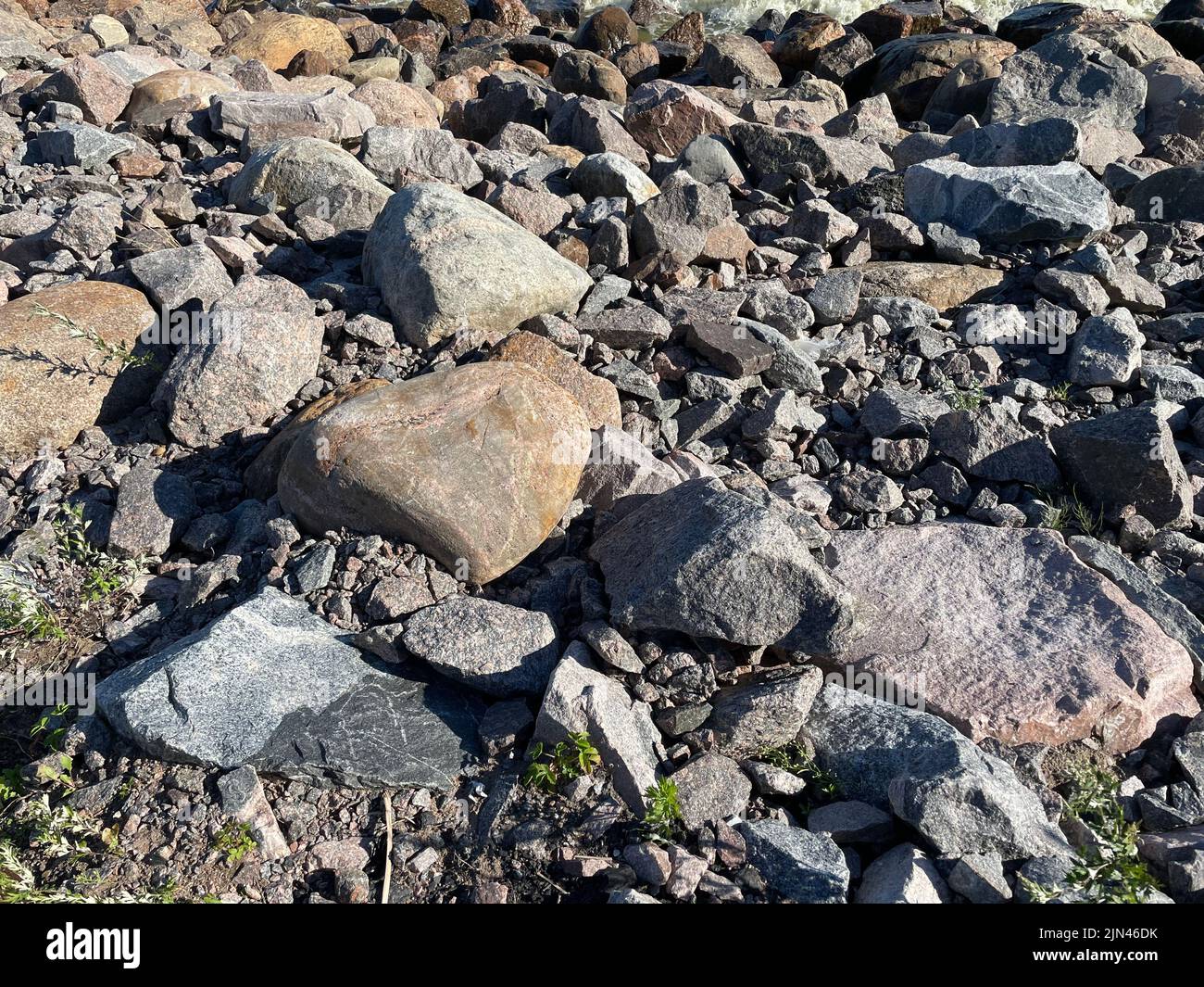 Pile of stones lies on the beach Stock Photo - Alamy