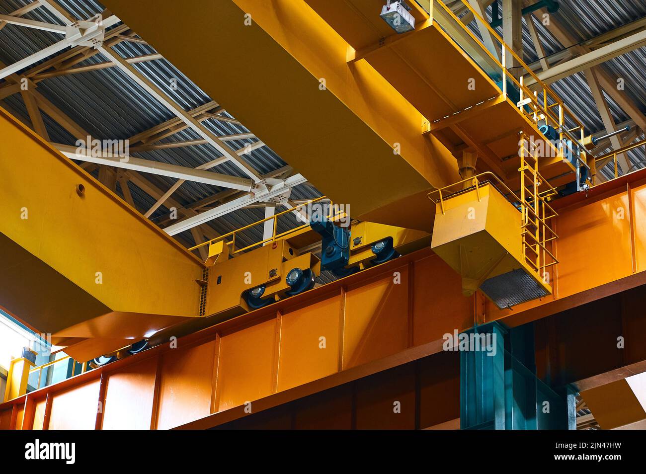 Service cabin on beam of yellow equipment at plant Stock Photo - Alamy
