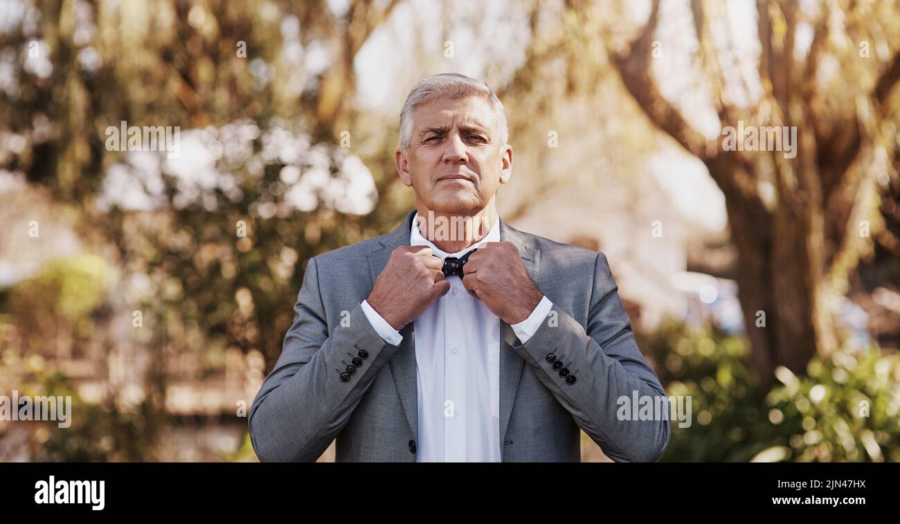 He knows the importance of a perfect necktie. Cropped portrait of a ...
