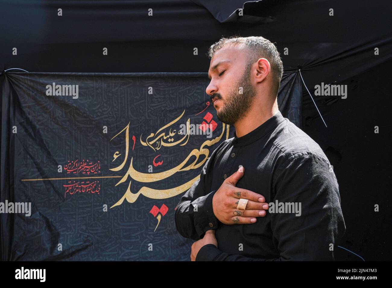 A Shiite Muslim man mourns during the procession. The first month in ...