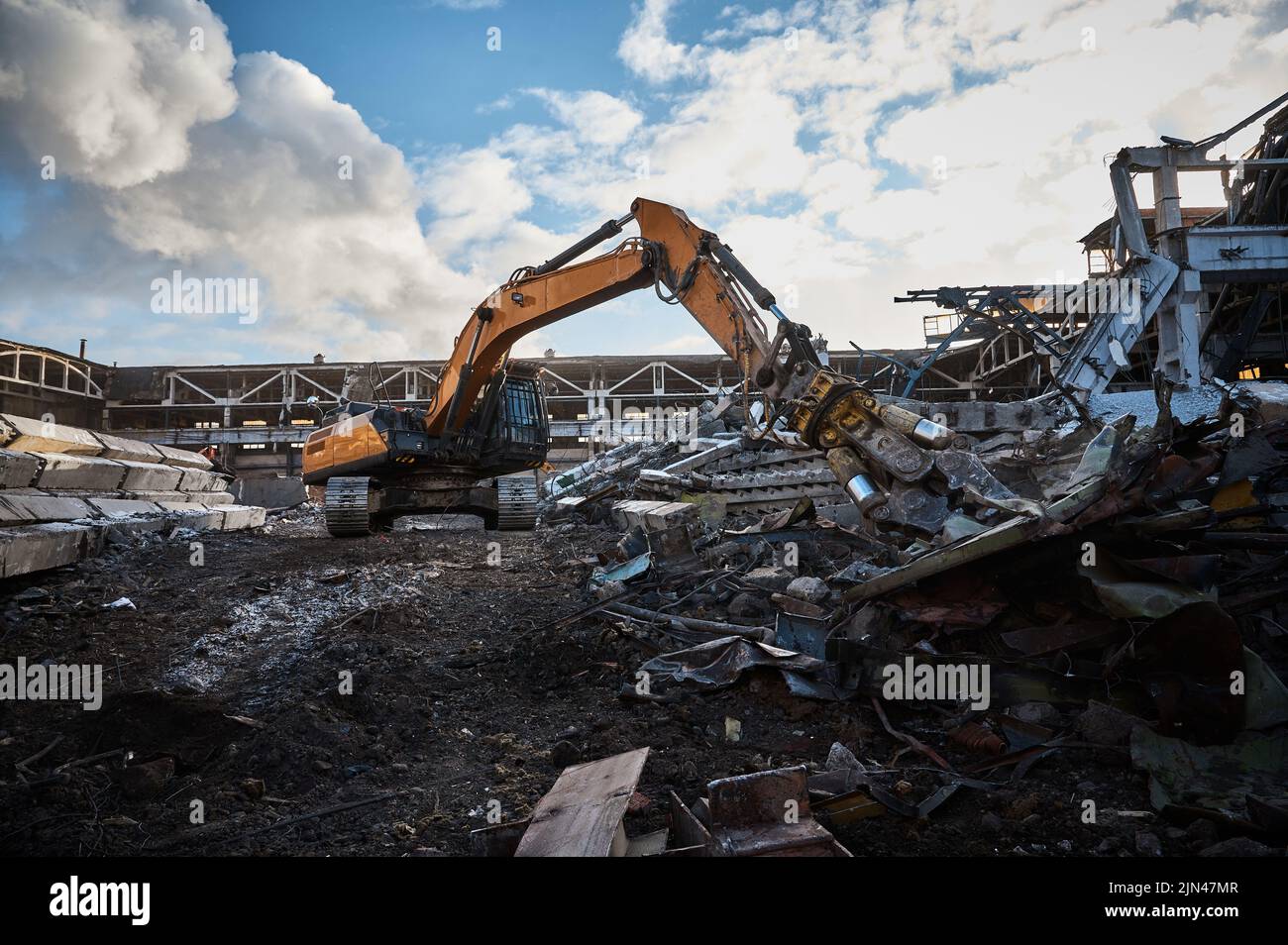 Excavator destroyer removes debris Building demolition Stock Photo - Alamy