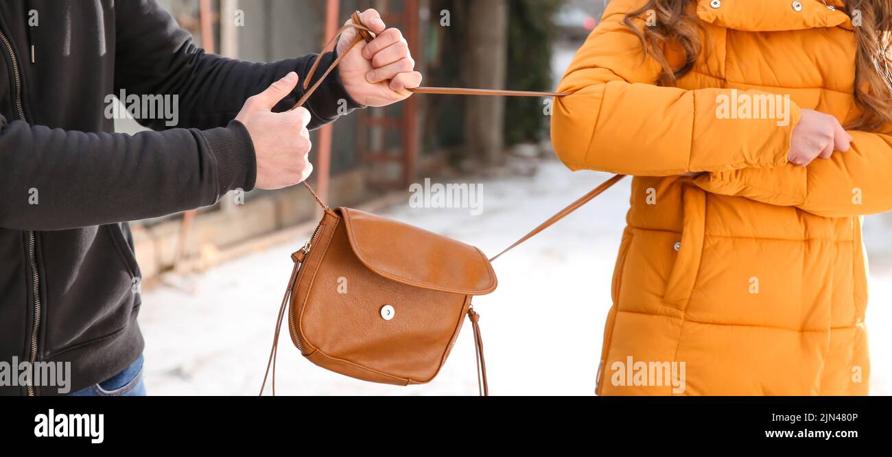 Male thief stealing bag from young woman outdoors Stock Photo - Alamy