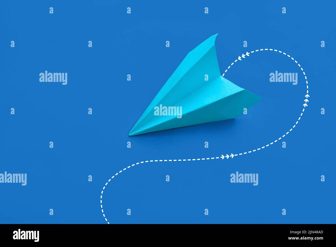 Paper plane on blue background Stock Photo - Alamy