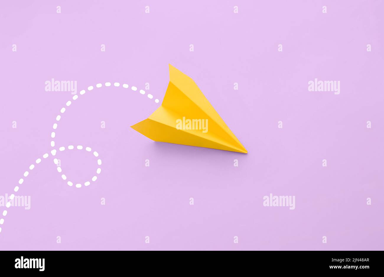 Yellow paper plane on lilac background Stock Photo - Alamy