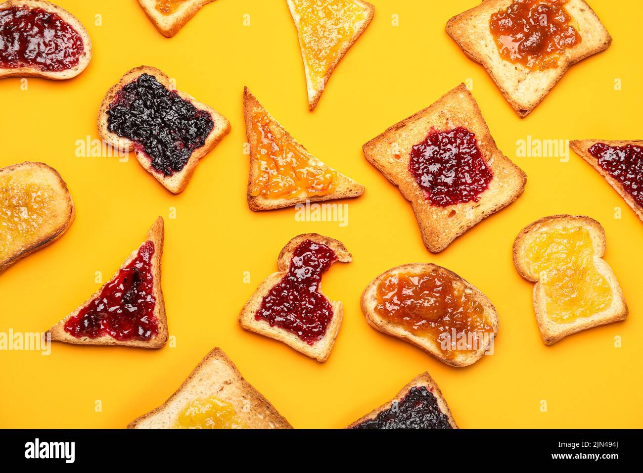 Many toasts with different jams on color background Stock Photo - Alamy
