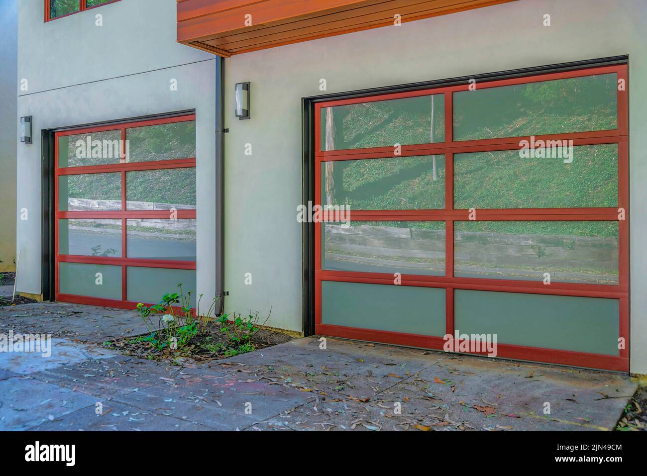 Modern garage exterior with two garage doors and wall lights in San ...