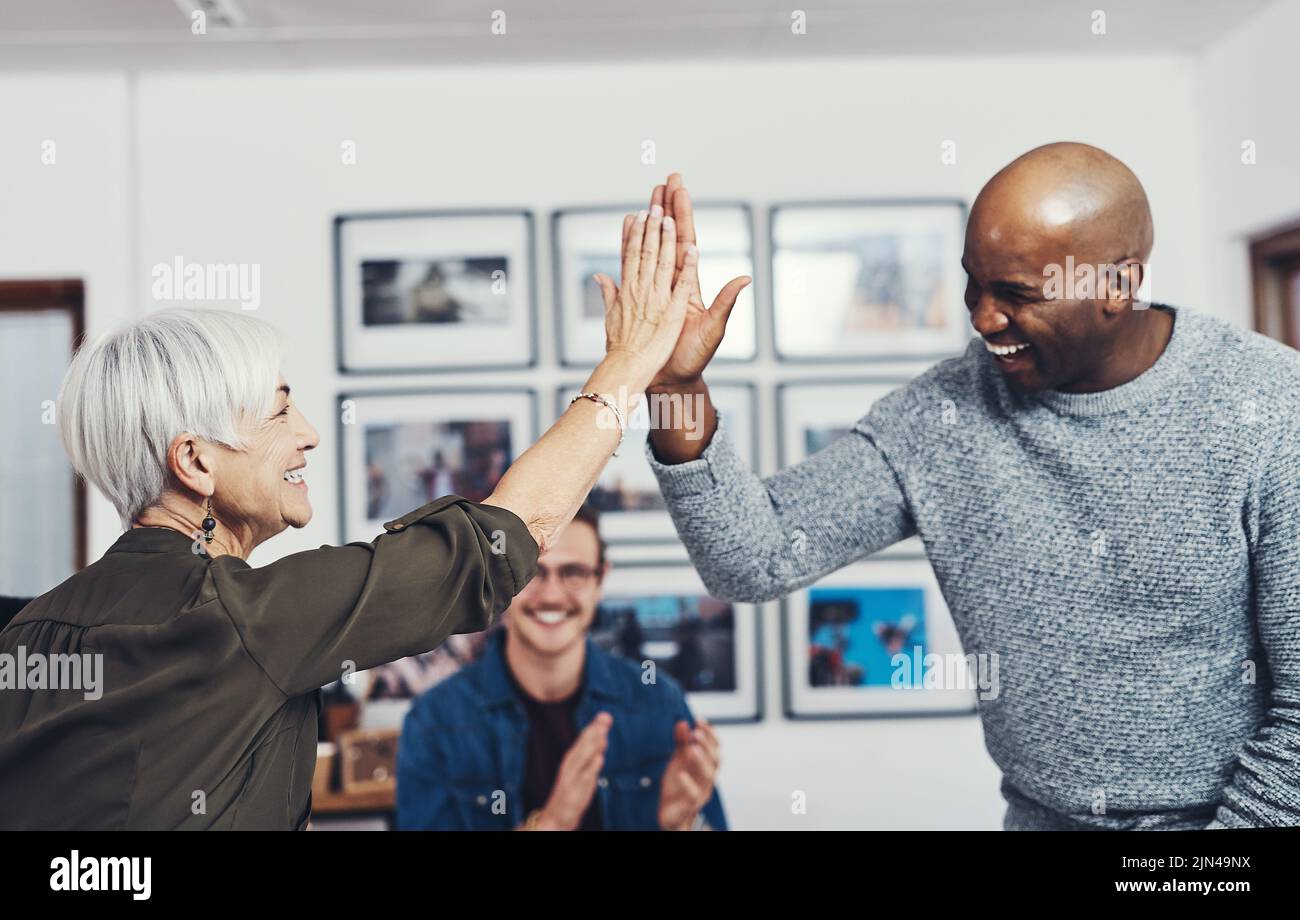 Going in for a high five. two cheerful businesspeople giving each other ...
