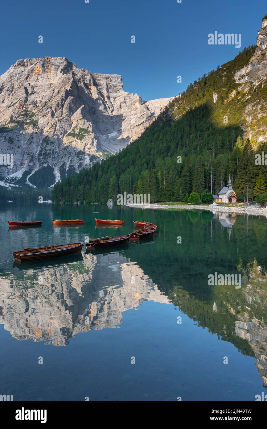 Amazing Sunrise view of Lago di Braies (Pragser Wildsee) with Wooden boats, one of the most ...