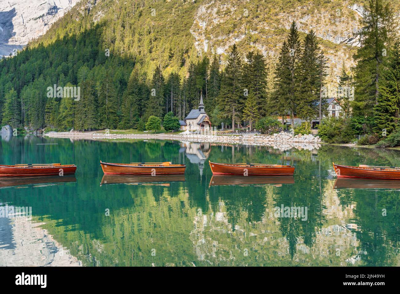 Amazing Sunrise view of Lago di Braies (Pragser Wildsee) with Wooden boats, one of the most ...