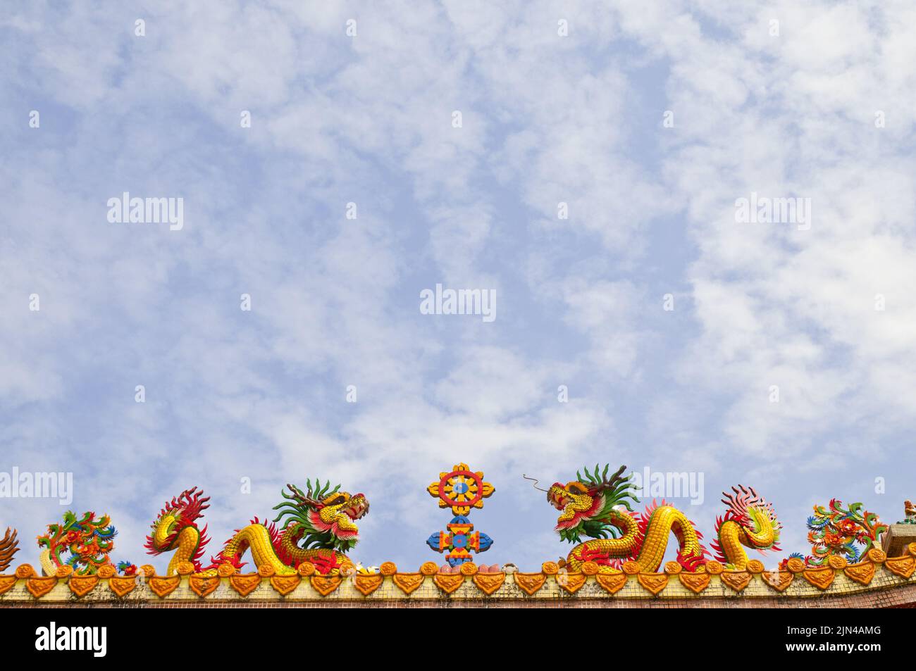 Two Golden artistic grand yellow Asian dragons statue on the roof of a ...