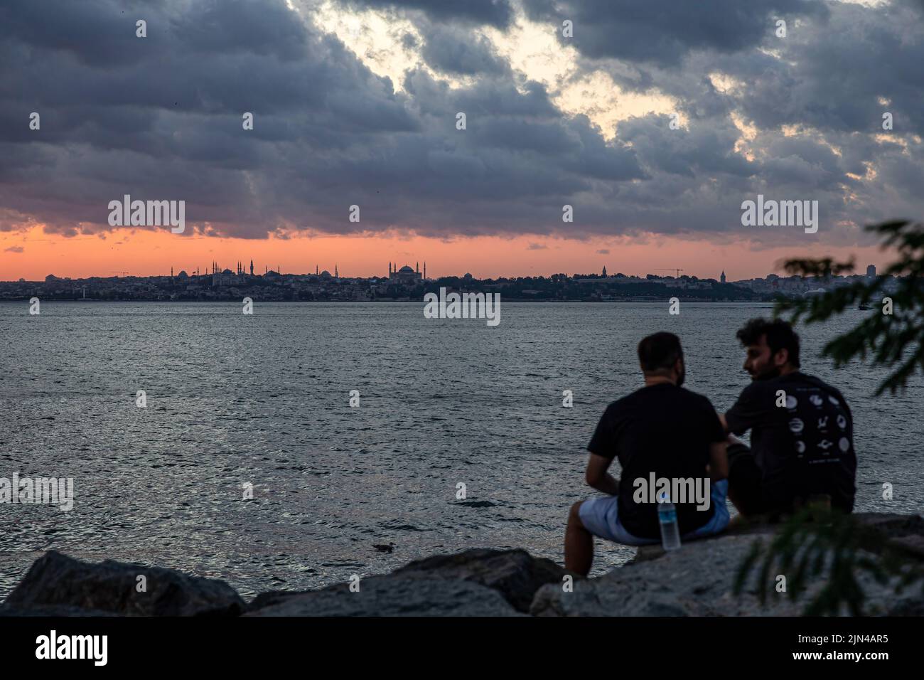 Istanbul, Turkey - 08 Aug 2022, People sit on the rocks while enjoying ...