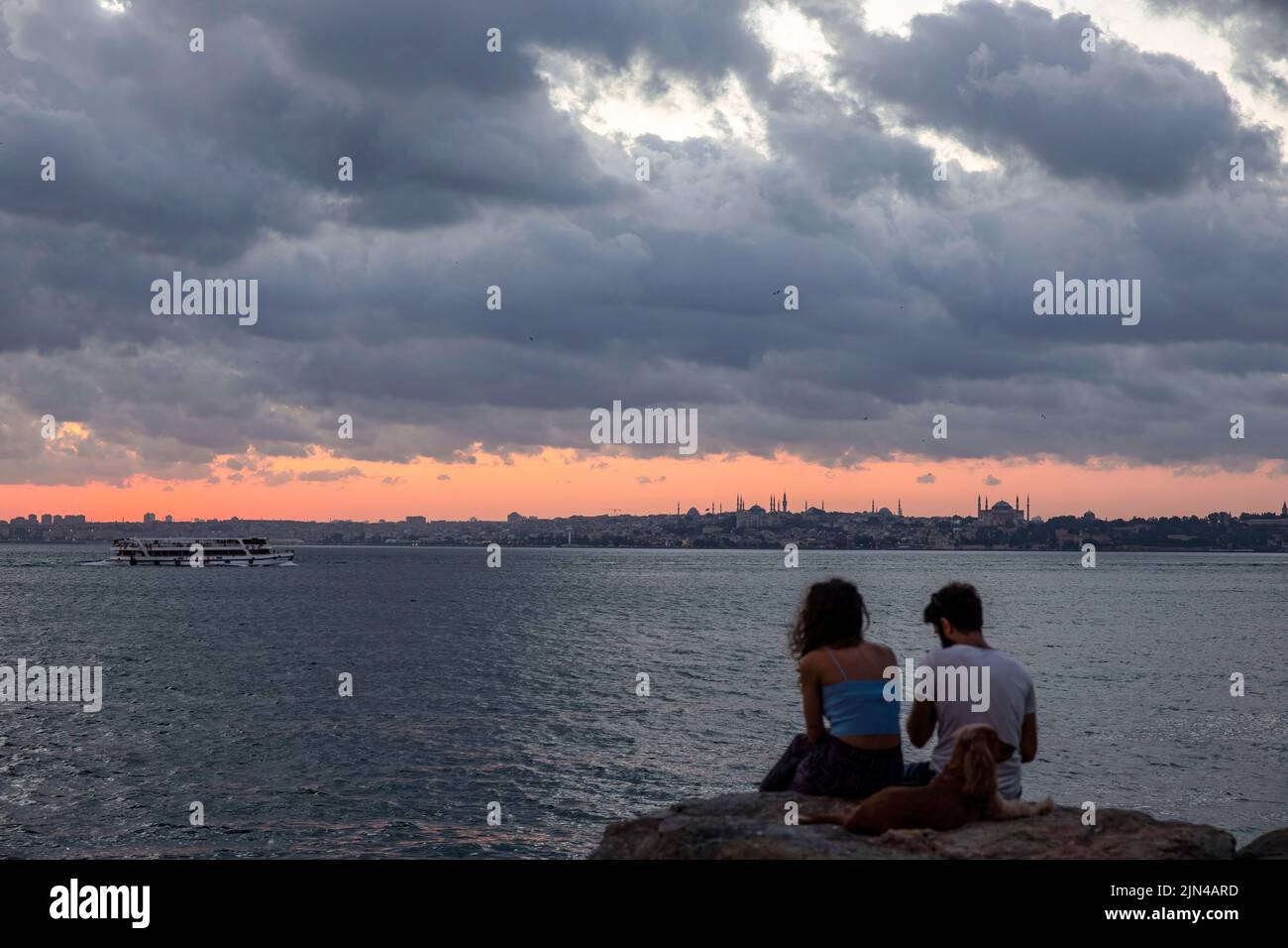Istanbul, Turkey - 08 Aug 2022, People sit on the rocks while enjoying ...