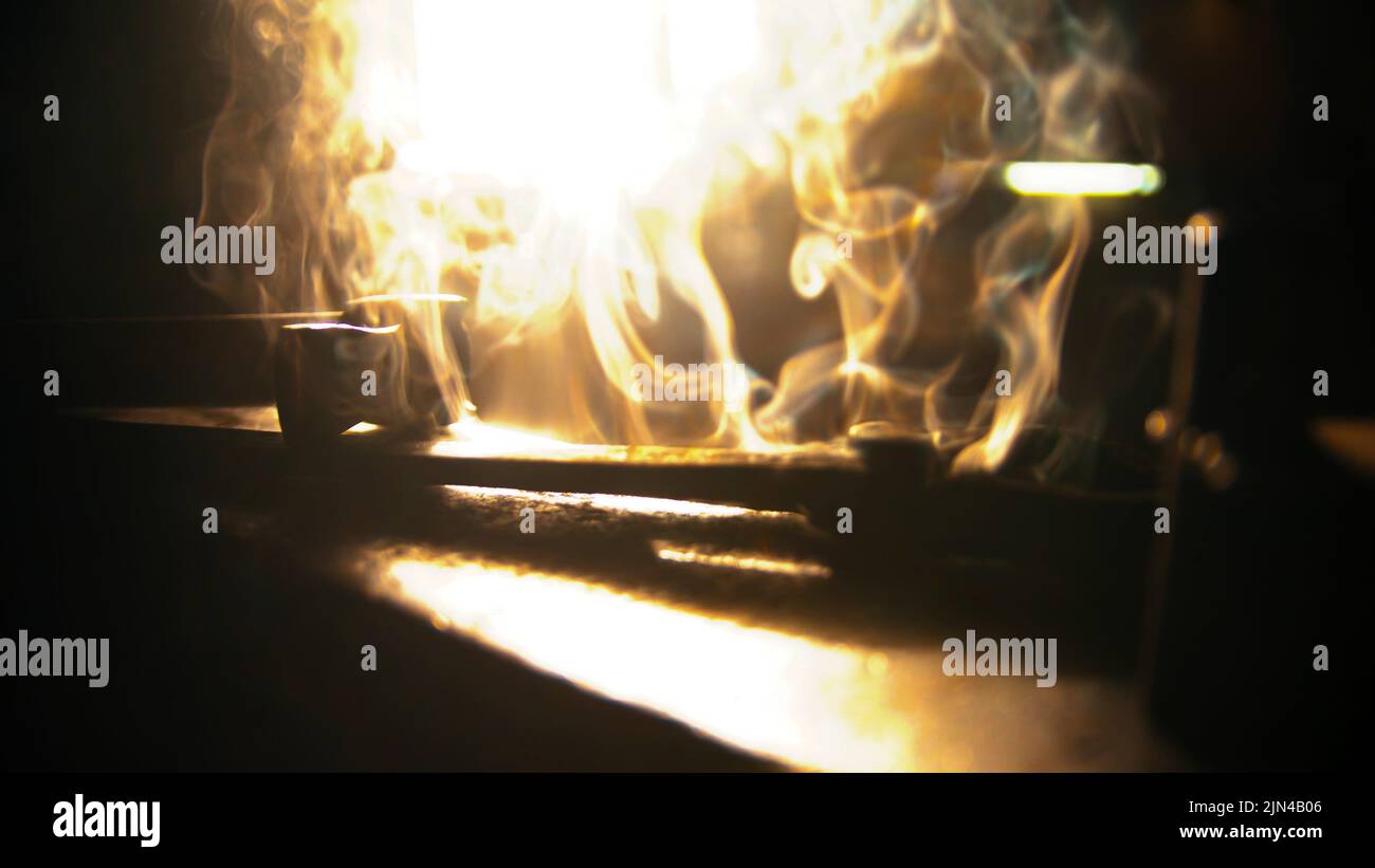 A blacksmith instrument lying on the anvil covered in flame Stock Photo ...