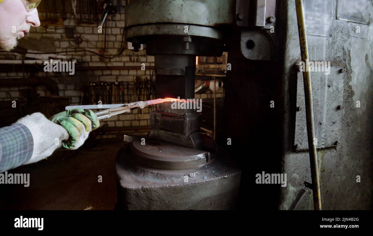 Blacksmith forming knife using industrial hi-res stock photography and ...