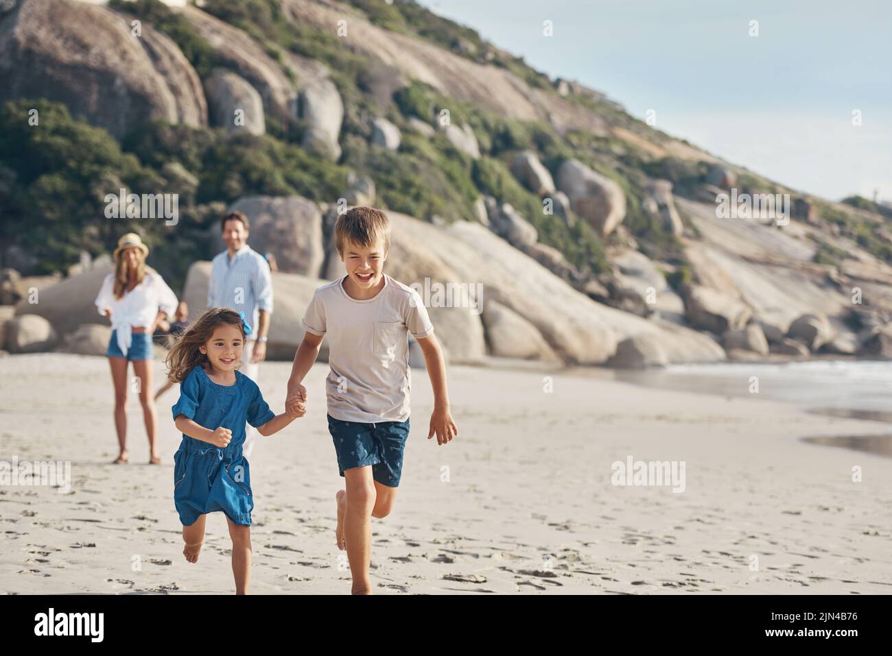 Two girls running holding hands hi-res stock photography and images - Alamy