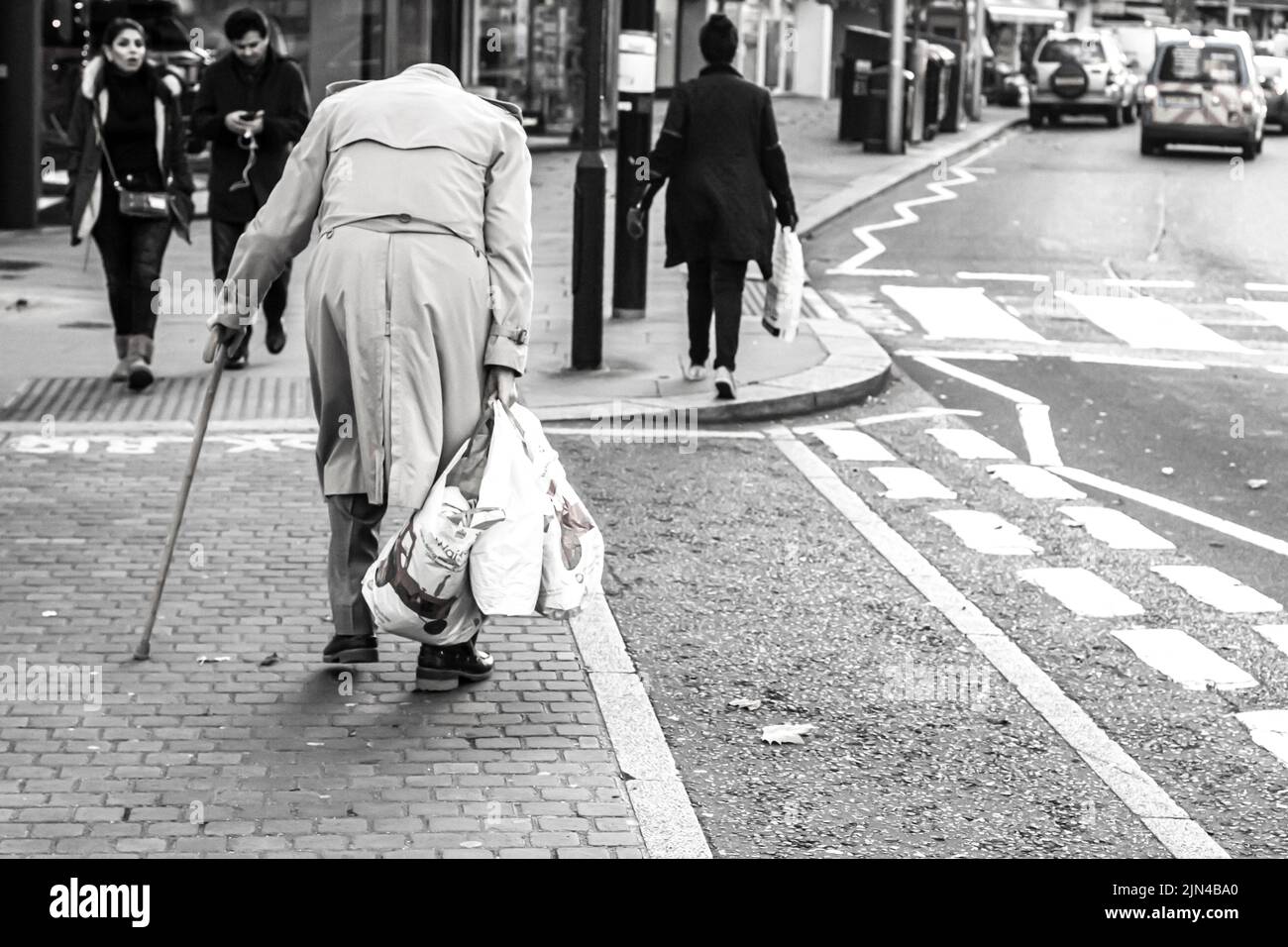 A deceptive grayscale shot of hunched man with no head crossing the ...