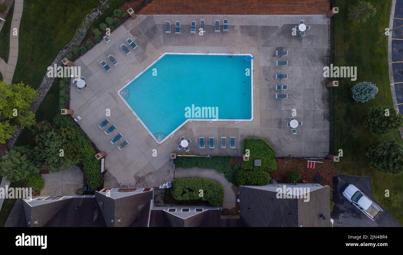 The top view of a swimming pool with benches surrounded by plants Stock ...