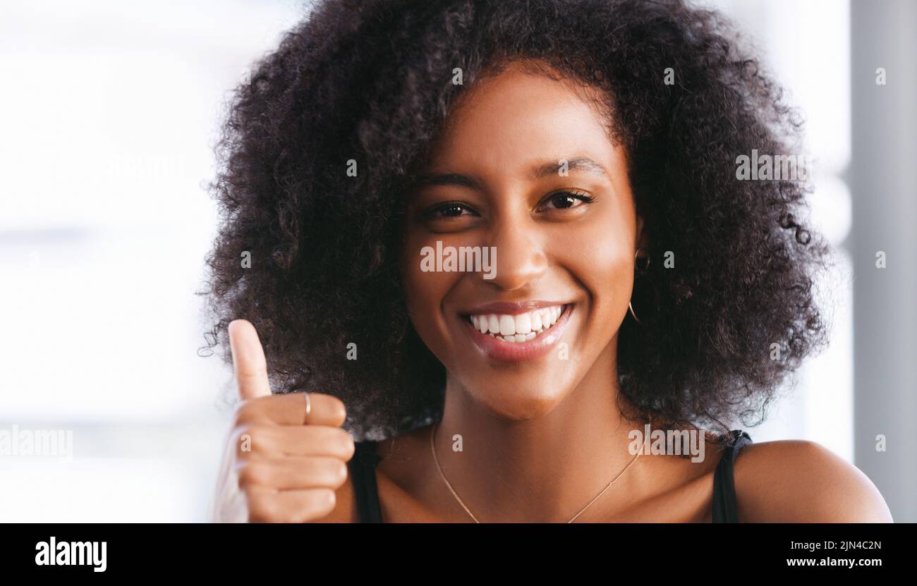 I love your posts. Portrait of a confident young woman showing a thumbs ...