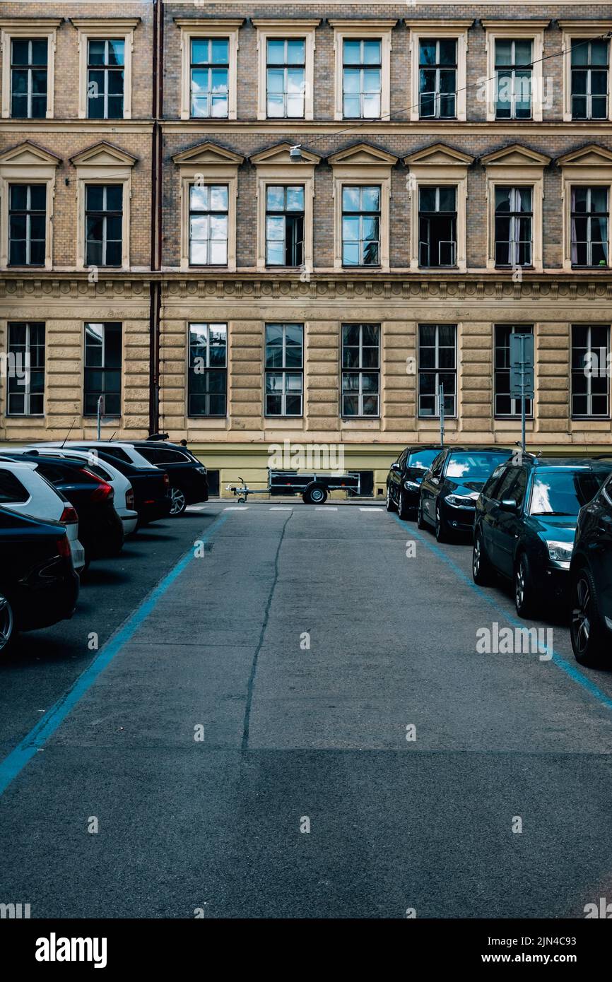 An outdoor view of a straight road in a parking lot against a ...