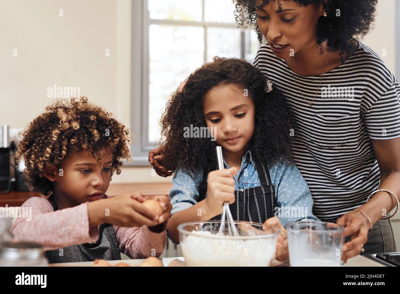 Were almost ready for the next step. two children baking at home with ...