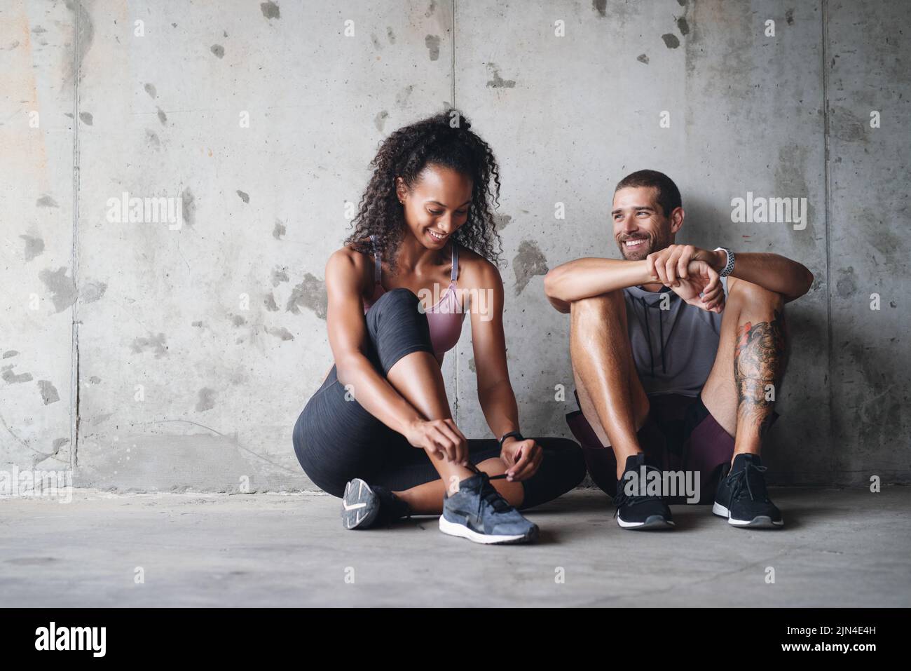 Get up and get going. Full length shot of a sporty young couple sitting ...