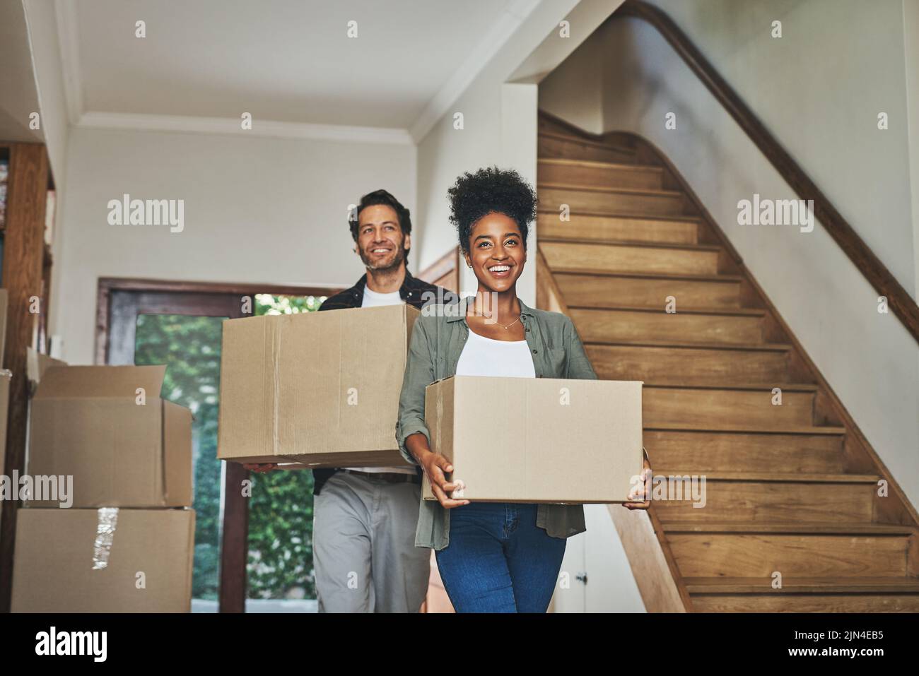 Walking into their very own space. an affectionate young couple smiling ...