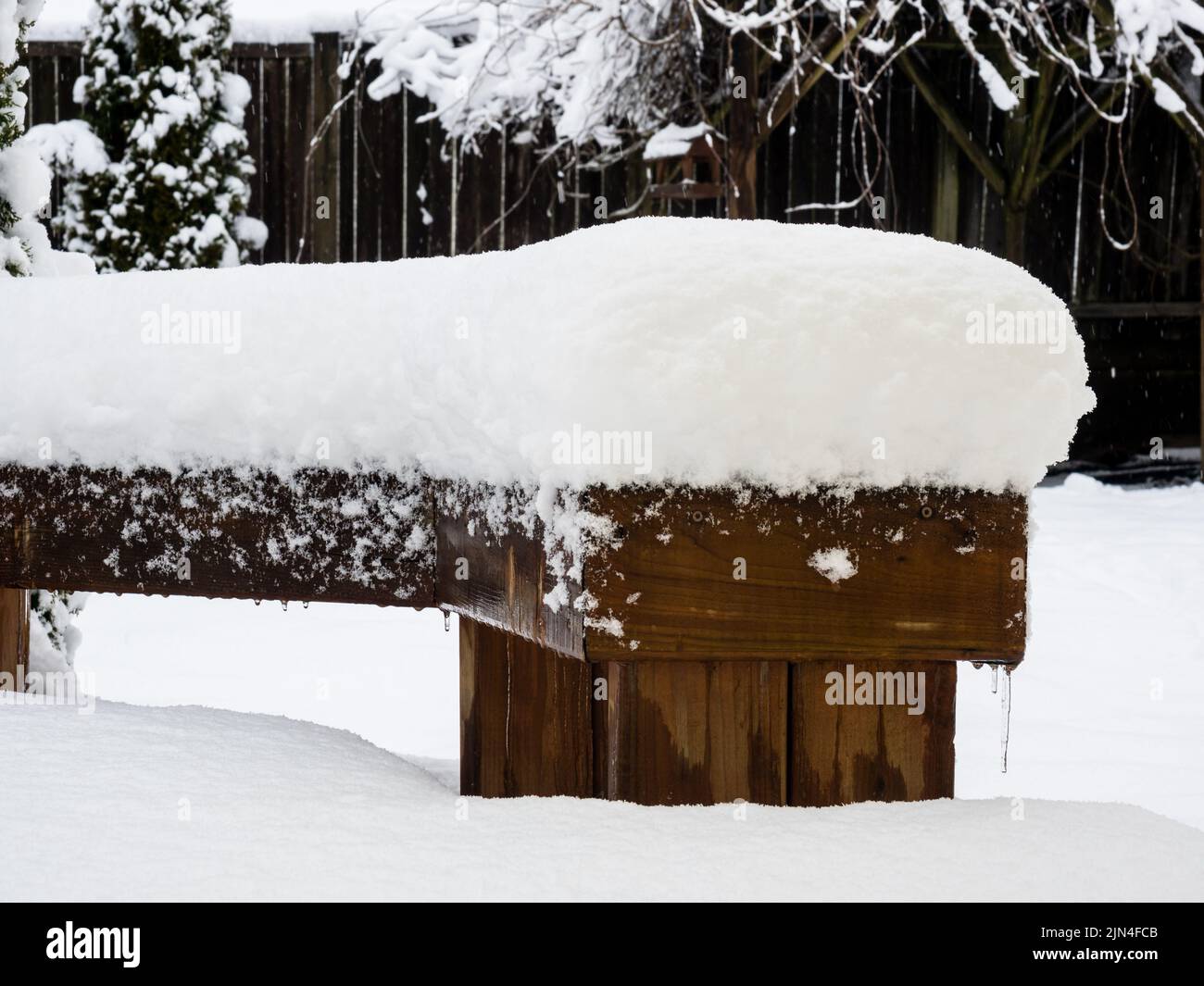 Wooden bench, deck and backyard covered in deep snow - Washington state ...