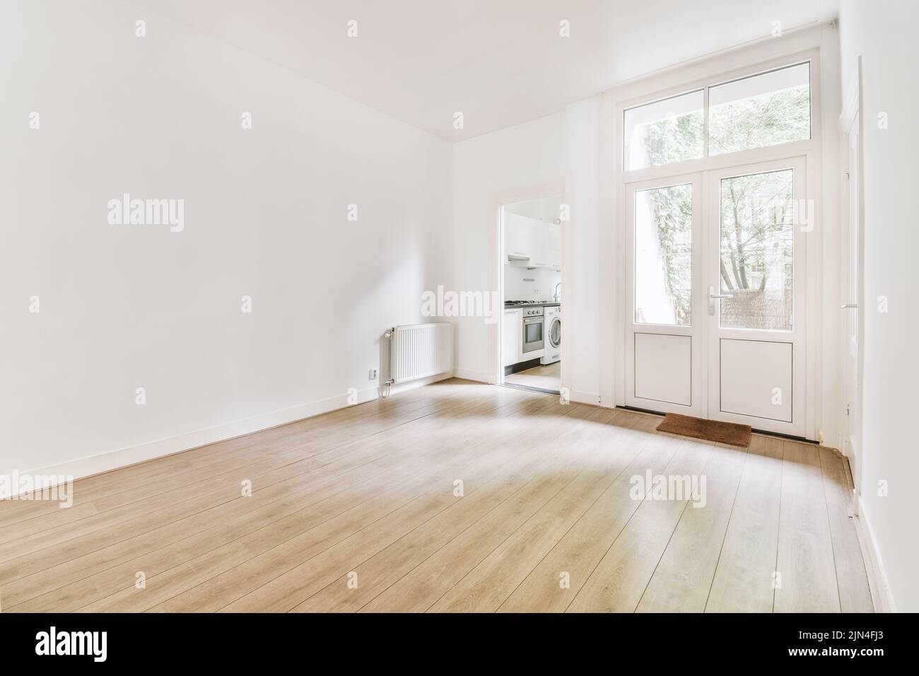 Plastic window and radiator on white wall in empty light room at home ...